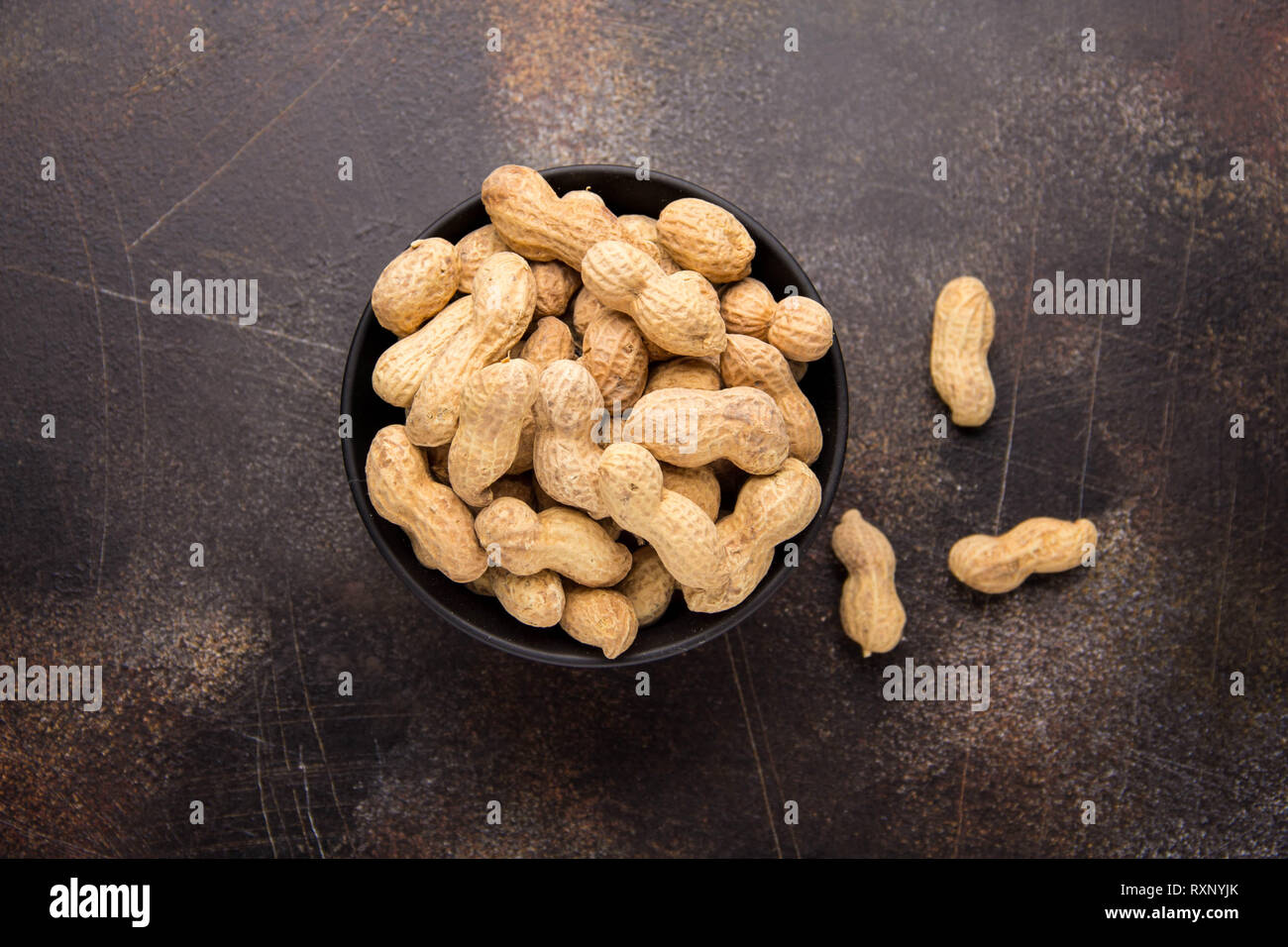Peanuts in shell in bowl on dark background. Healthy food, whole ...