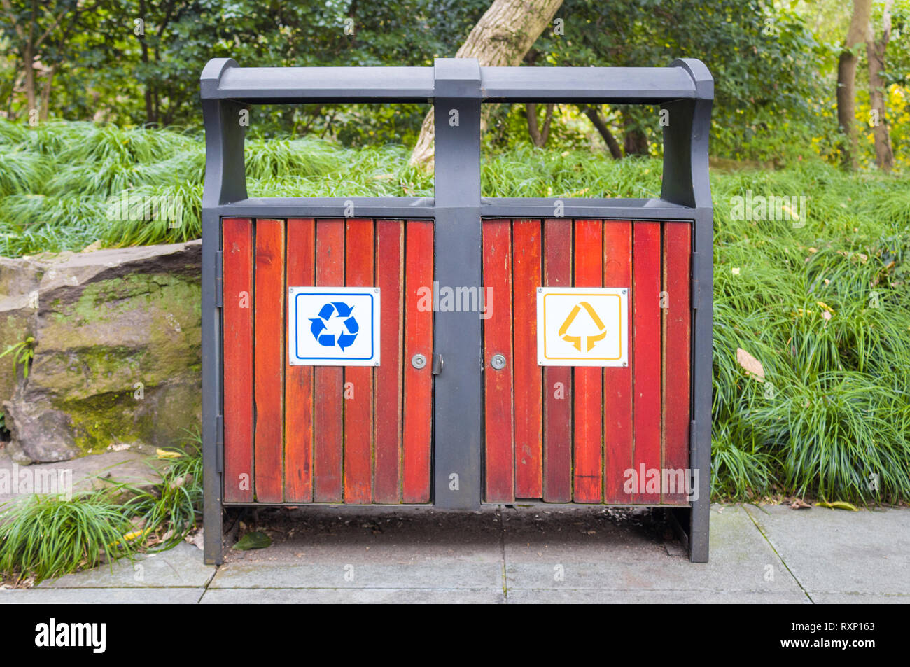 Trash bins with sorting signs in the park on grass background Stock ...