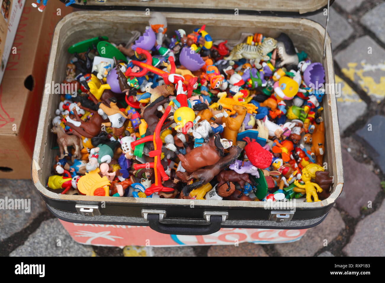 Colorful toy, plastic toy, figures on a flea market in a suitcase ...