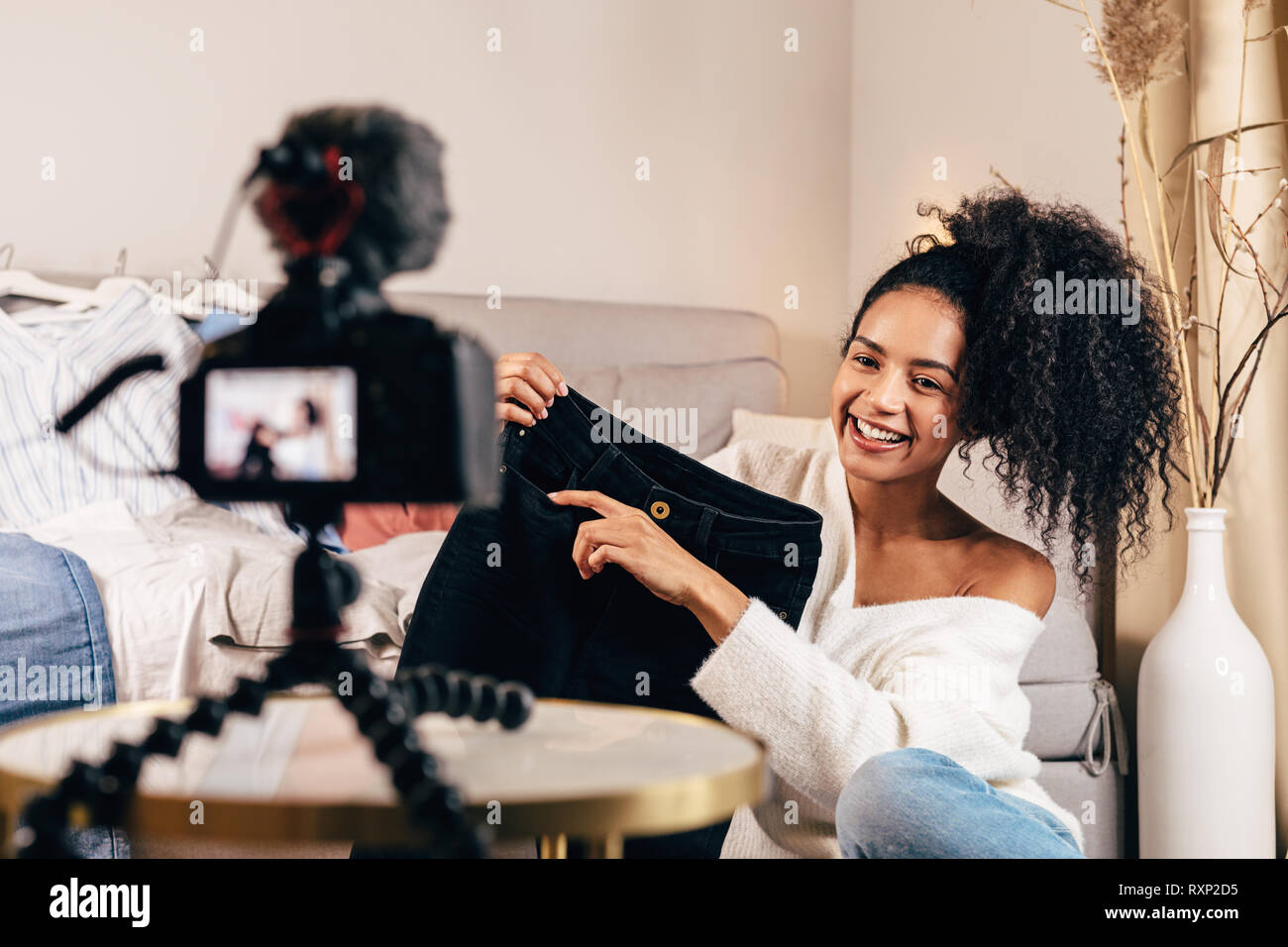 Fashion vlogger reviewing and marketing black jeans Stock Photo - Alamy