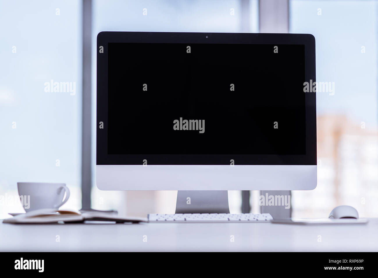 Mock up black empty desktop computer screen on desk at office business ...