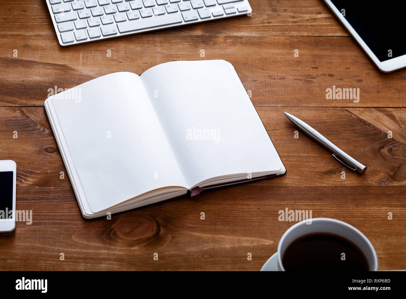 Work space desk with open paper empty white blank page notebook for ...