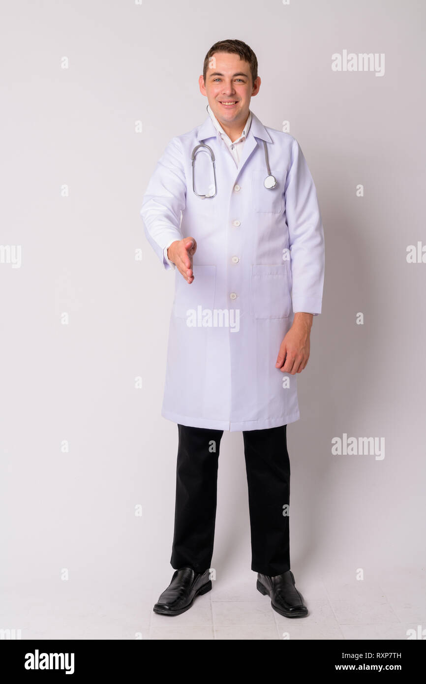 Full body shot of happy handsome man doctor giving handshake Stock ...