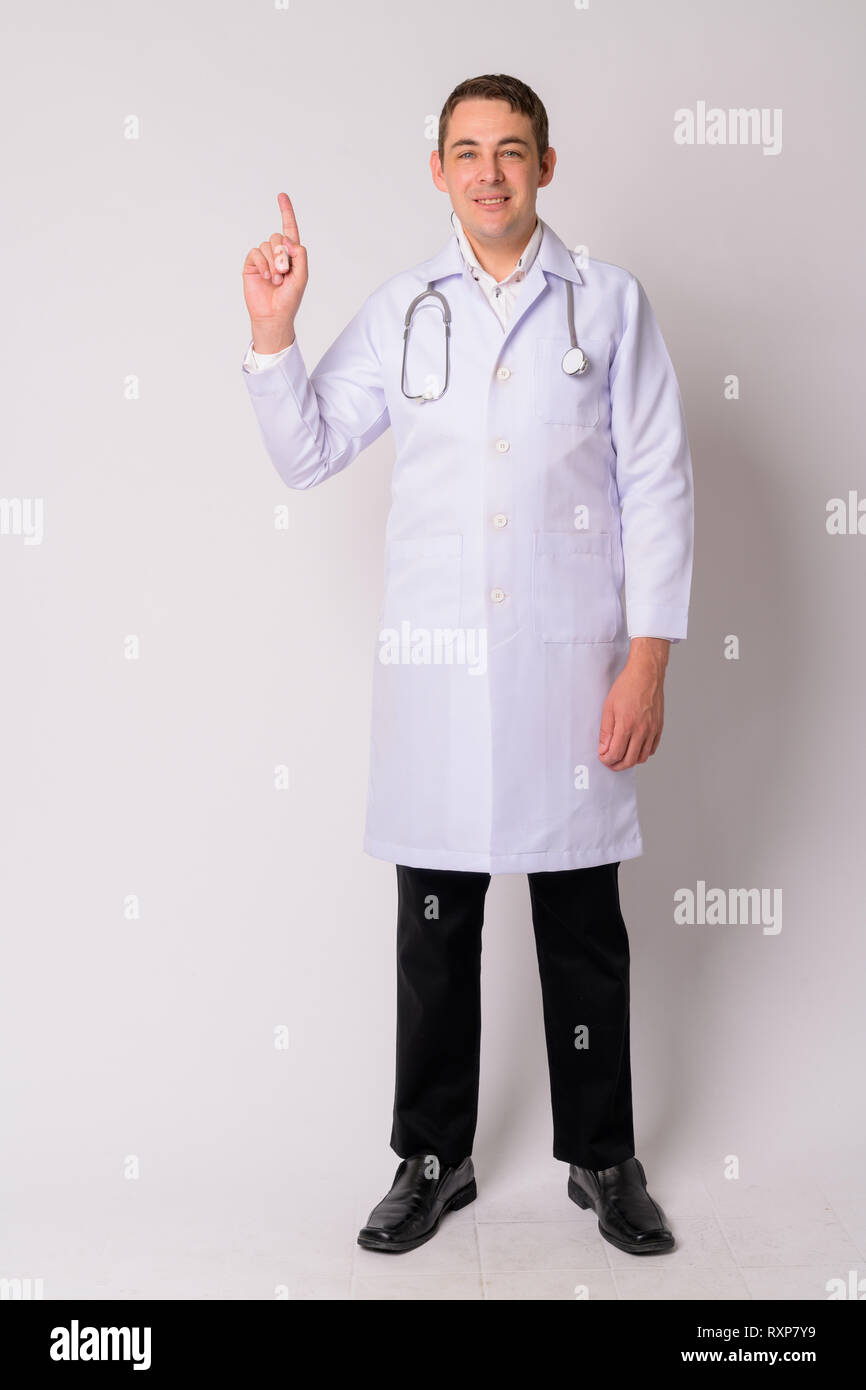 Full body shot of happy handsome man doctor pointing up Stock Photo - Alamy