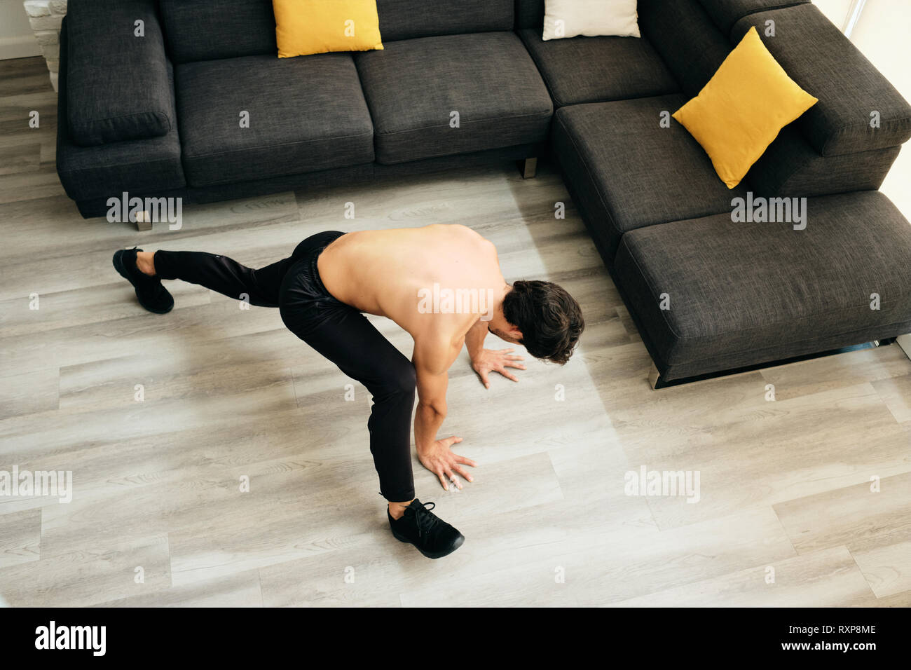 Fit young white man training at home. Handsome hispanic male athlete ...