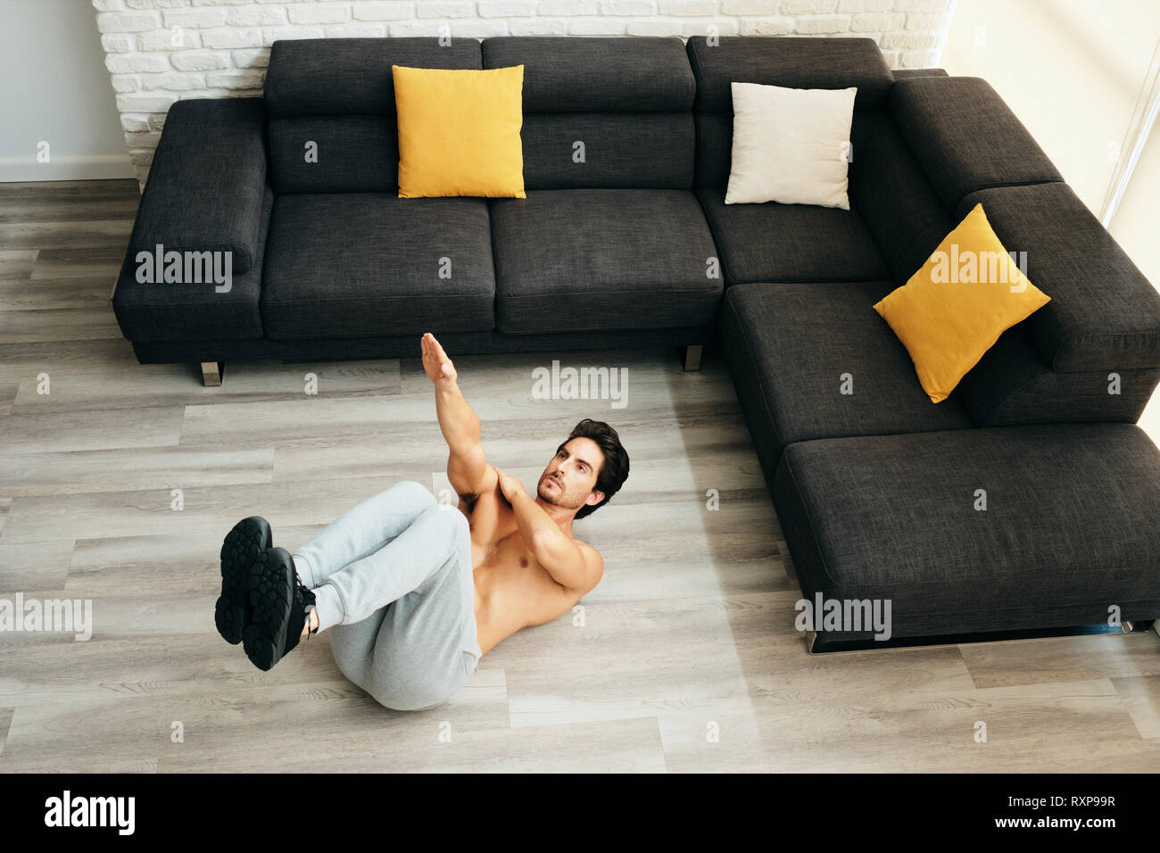 Fit young white man training at home. Handsome hispanic male athlete ...
