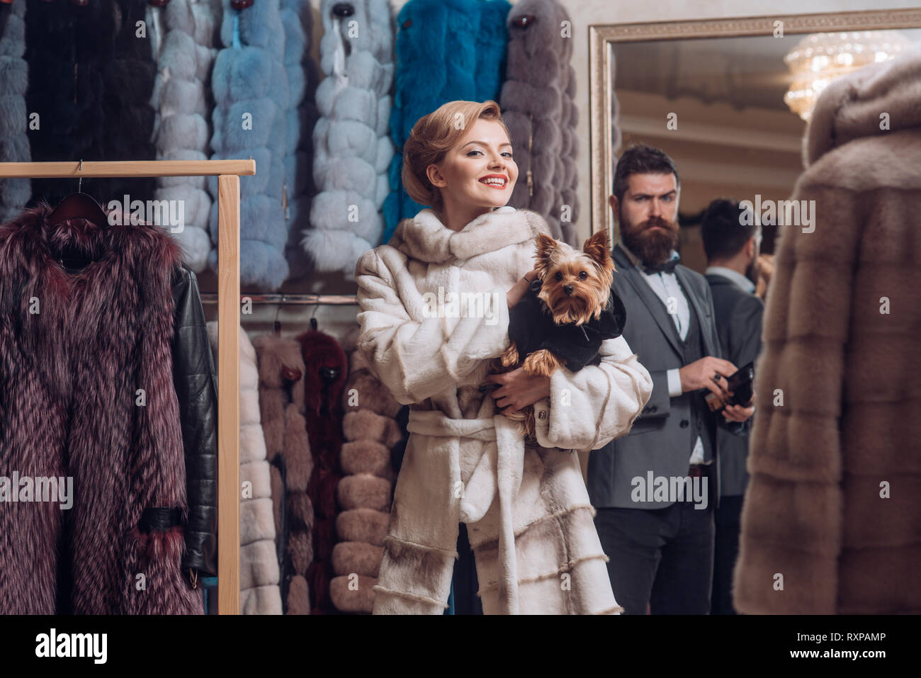 Woman in fur coat with man, shopping, seller and customer Stock Photo ...