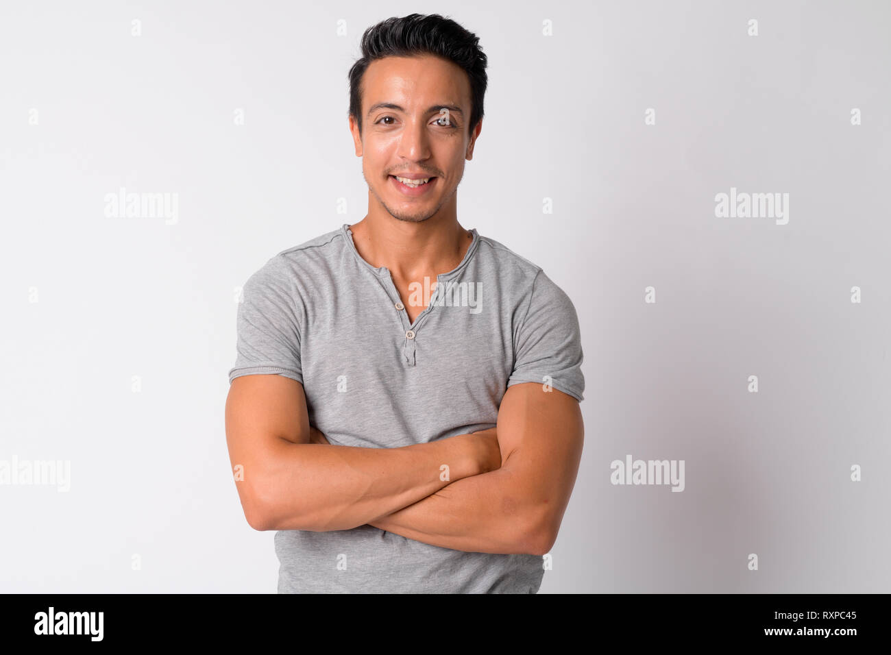 Portrait of happy Hispanic man smiling with arms crossed Stock Photo ...
