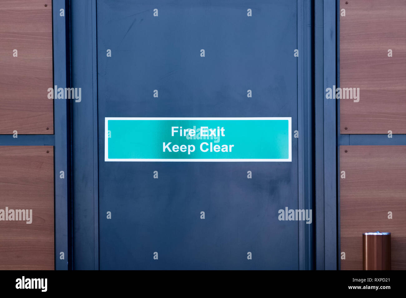 Fire exit keep clear sign on black door Stock Photo - Alamy