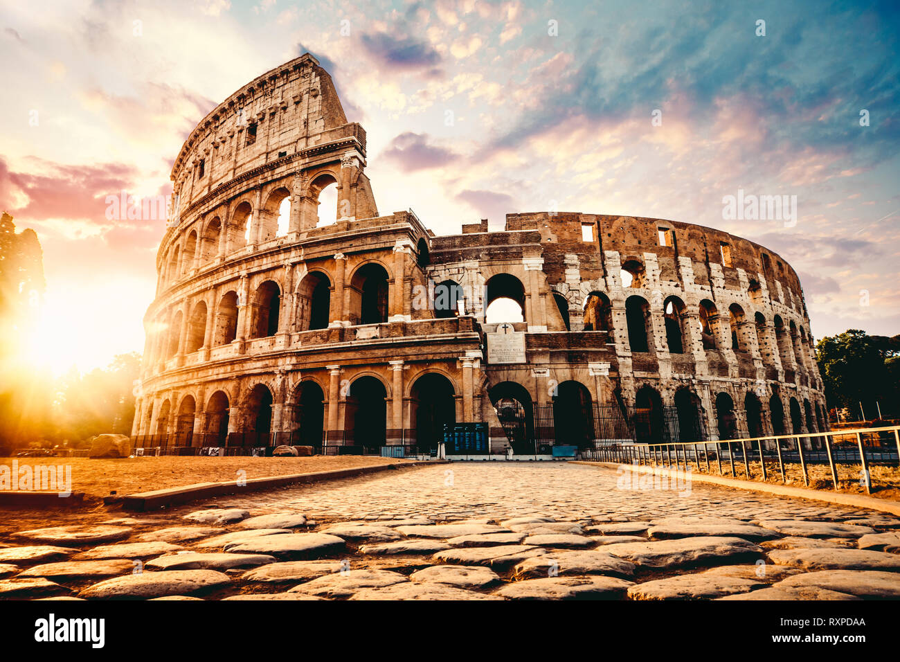 The ancient Colosseum in Rome at sunset Stock Photo - Alamy