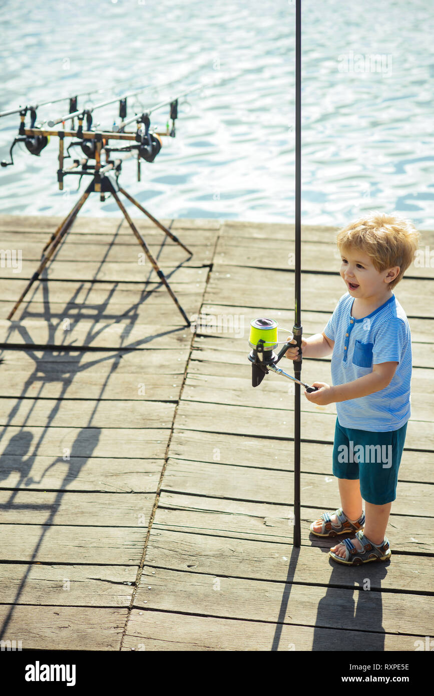 Child with fishing rod on wooden pier Stock Photo - Alamy