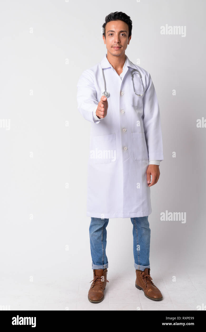 Full body shot of handsome Hispanic man doctor giving handshake Stock ...