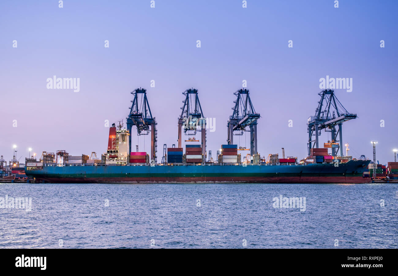Loading cargo container ship port at twilight in Sriracha industrial ...
