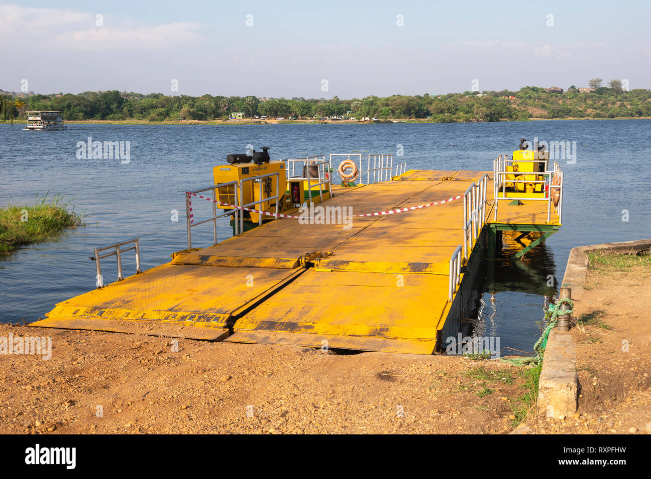 Ferry transporting vehicles and people across the Victoria Nile river ...