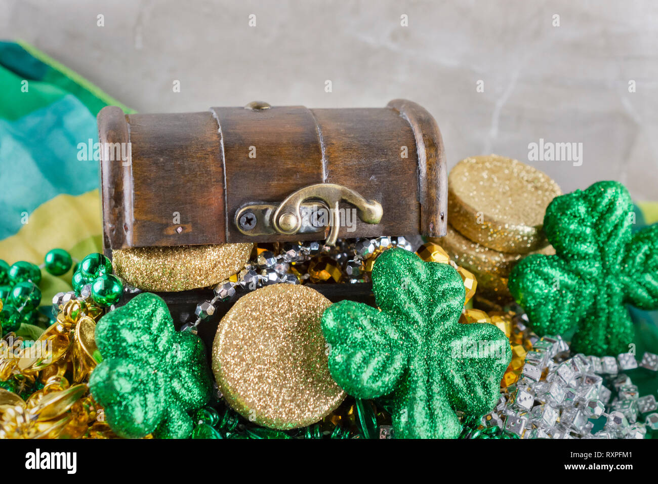 Saint Patrick's Day treasure chest filled with coins and beads. Close ...