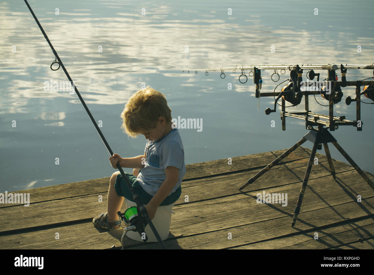 Cute boy fishing on river Stock Photo - Alamy
