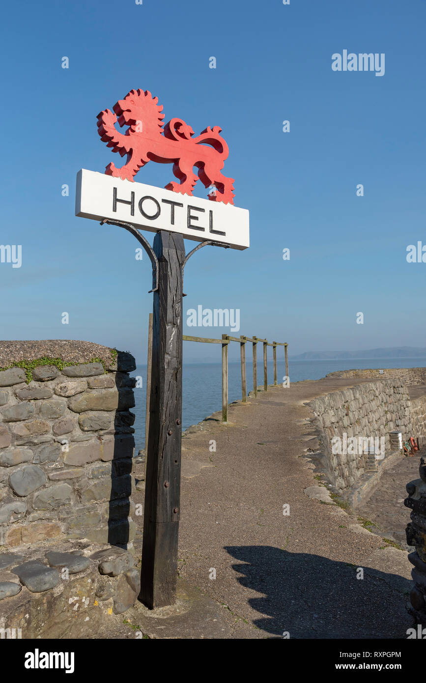 Clovelly, Devon, England, UK, March 2019. red hotel sign mounted on an ...