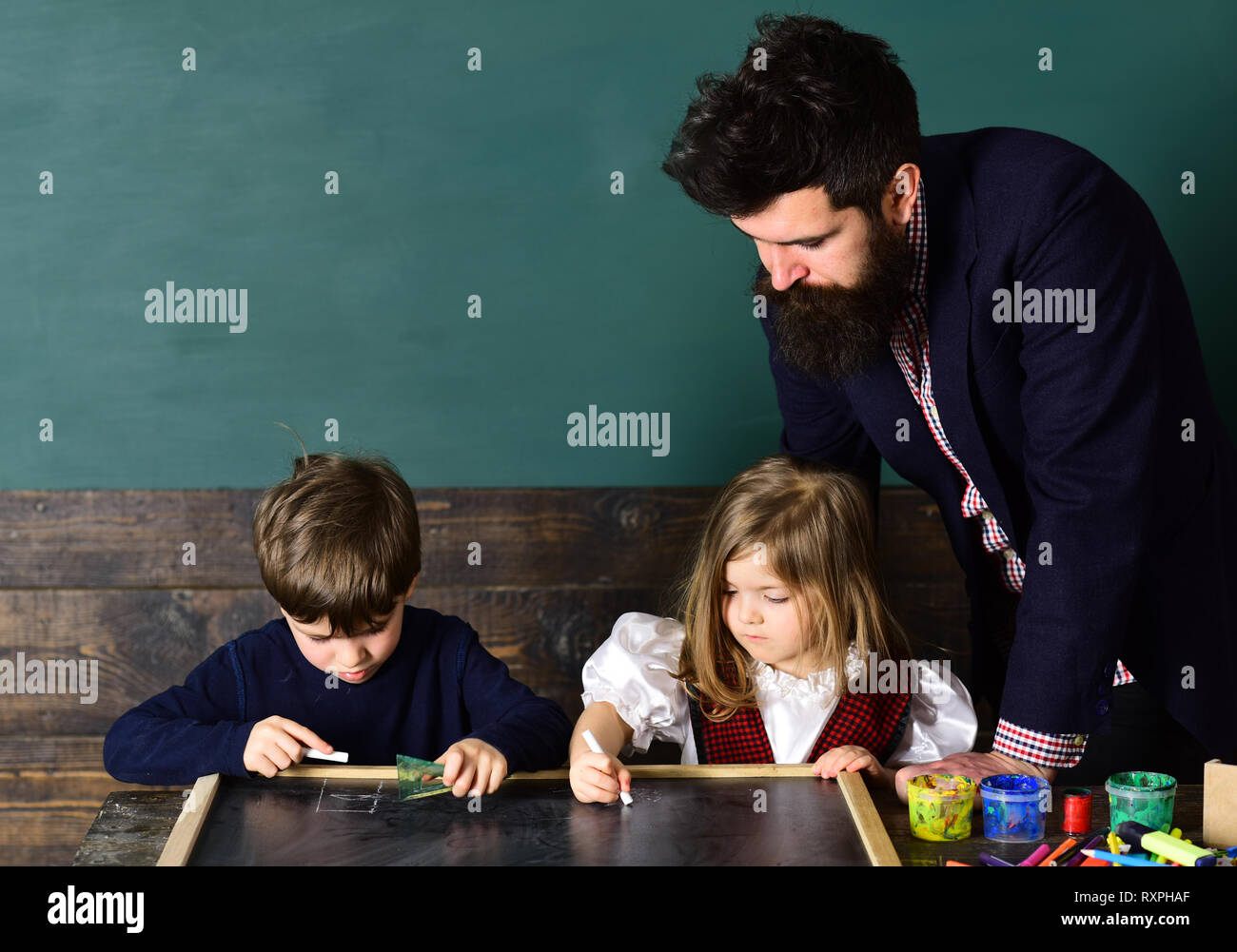 Girl helping boy homework in class hi-res stock photography and images ...