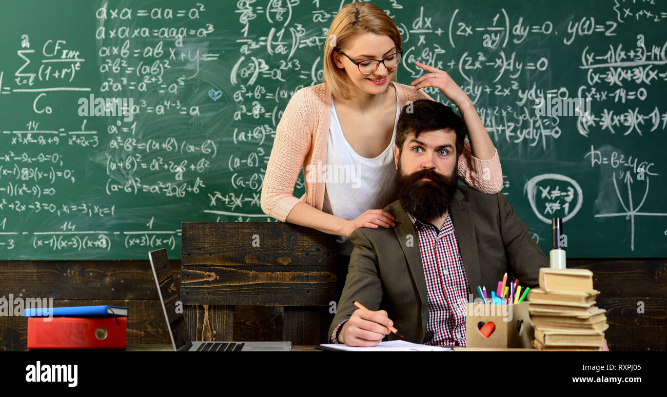 Teacher or tutor helps preschool child, Business tutor typing on laptop ...