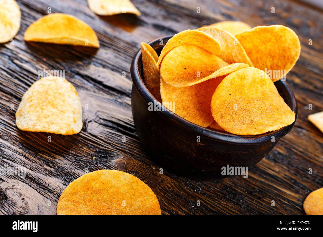 potato chips on a wooden table, in a clay plate. place for text Stock ...