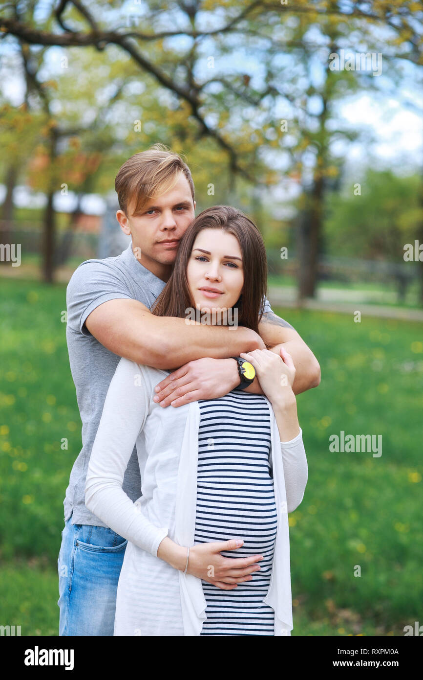 Happy couple expecting pregnancy portrait outdoor Stock Photo - Alamy