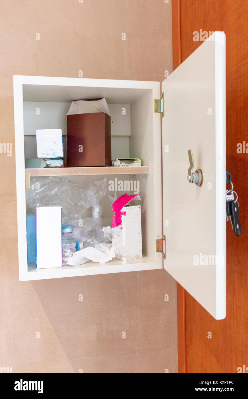 A close up view of a open medicine cabnet in a hospital room with the ...