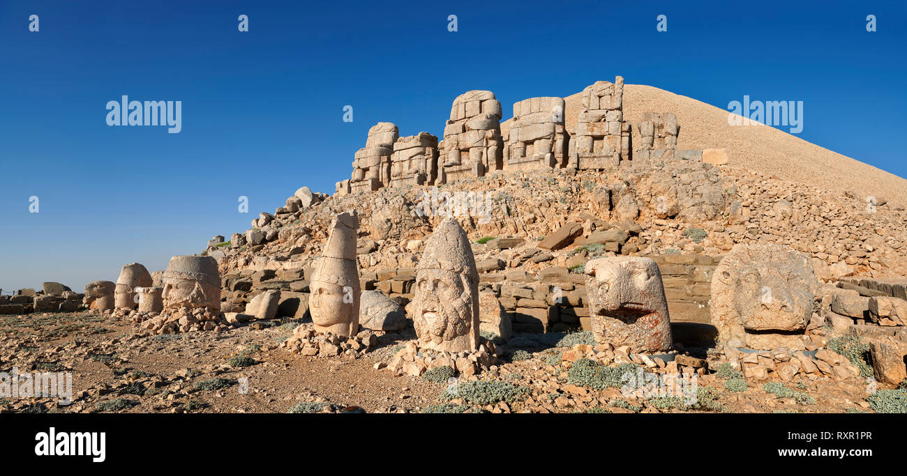 Statue heads with headless seated statues in front of the stone pyramid ...