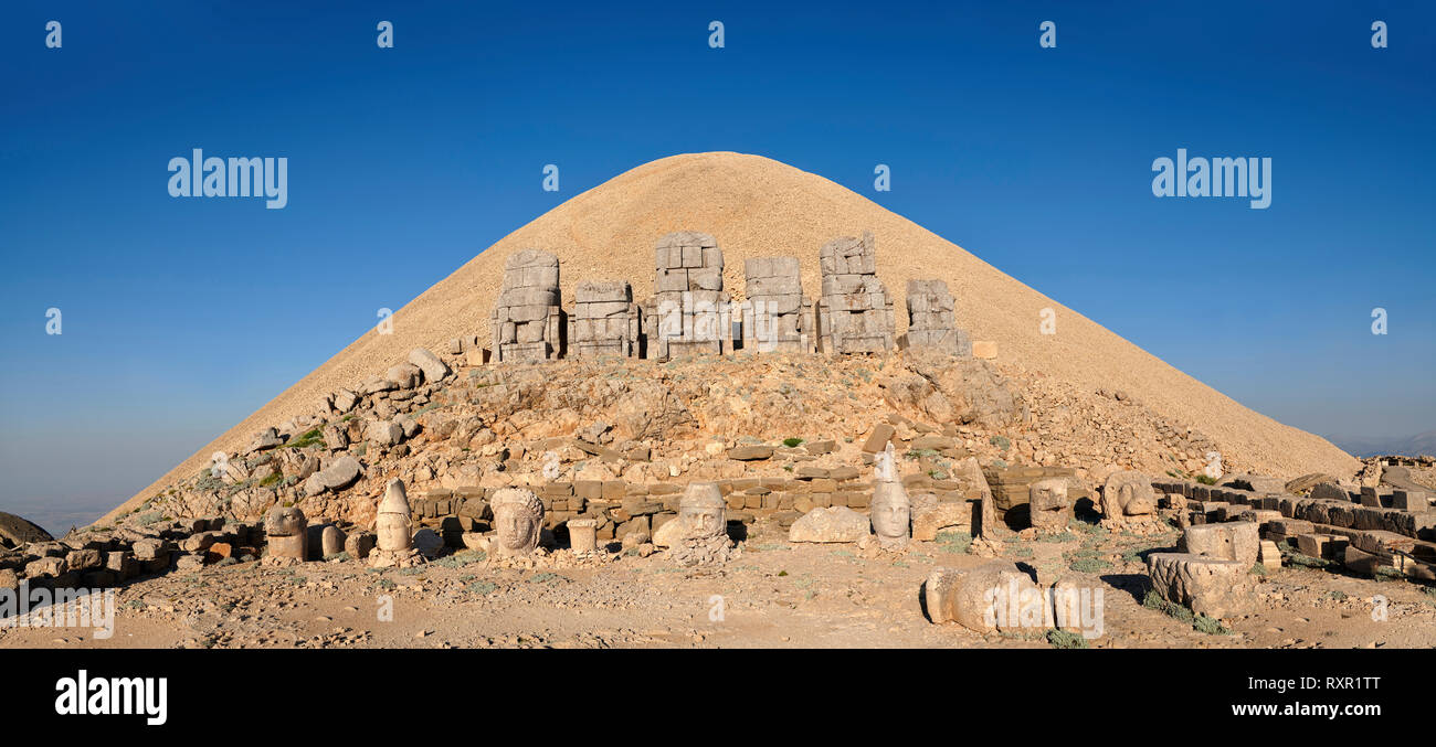 Statue heads with headless seated statues in front of the stone pyramid ...