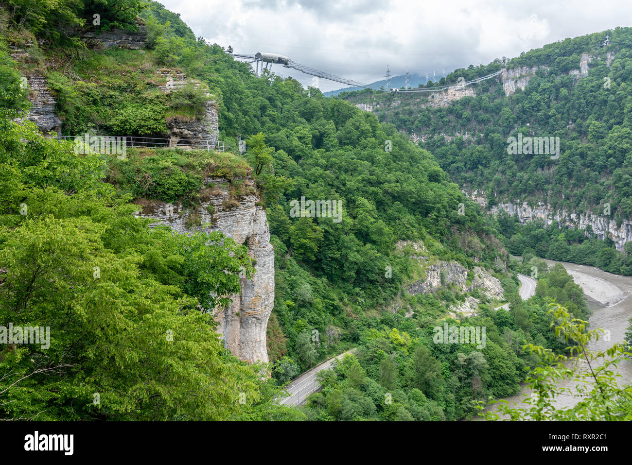 Skybridge suspension bridge over a gorge over an abyss with a river and ...
