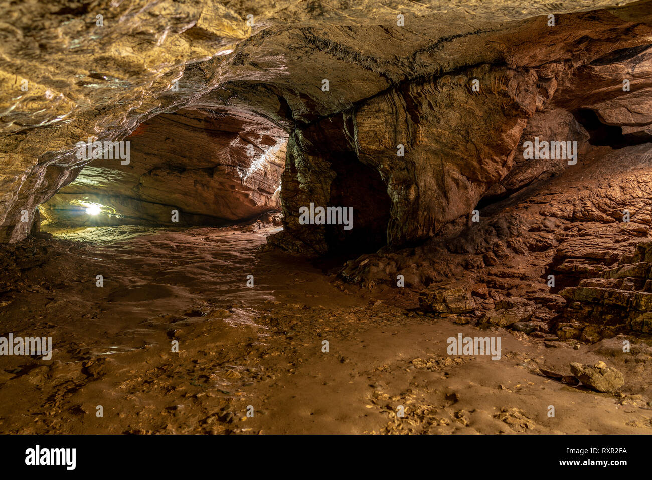 View inside the ancient cave with stone walls with additional lighting ...
