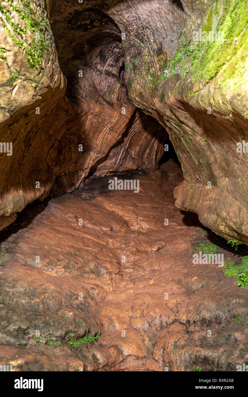 View inside the ancient cave with stone walls with additional lighting ...