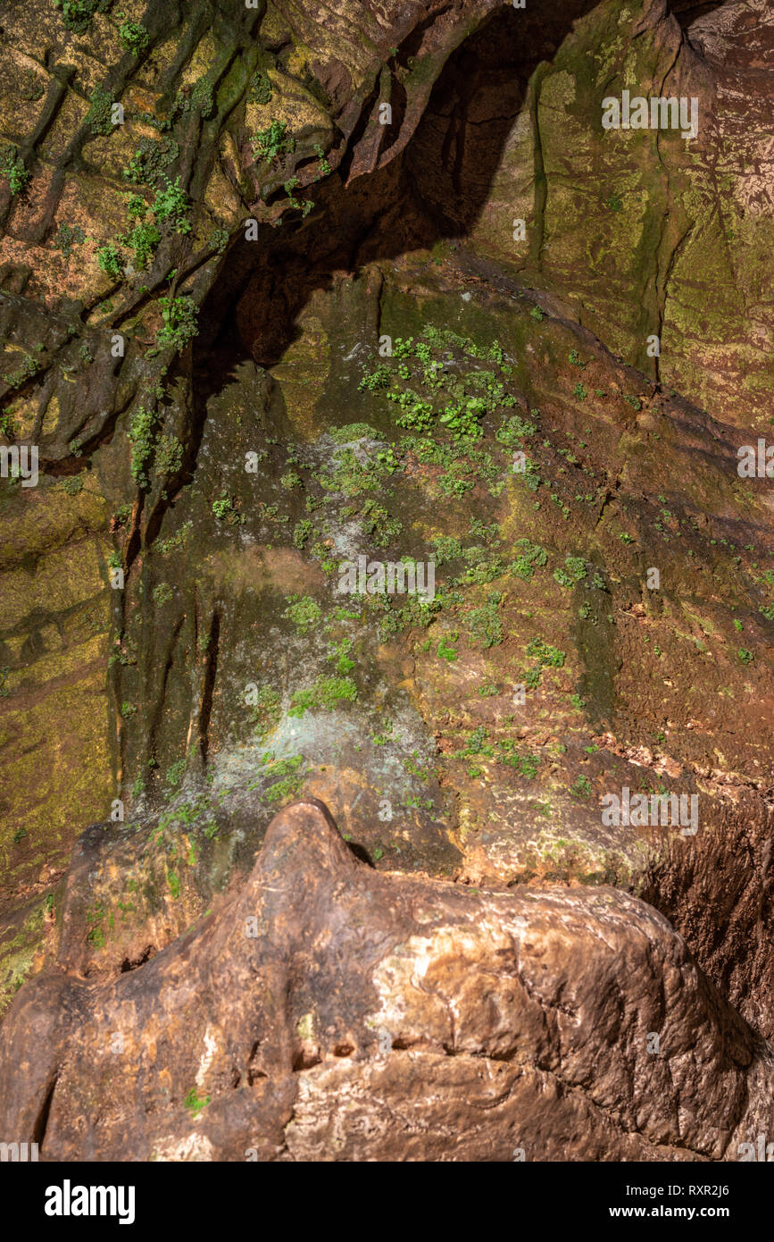 View inside the ancient cave with stone walls with additional lighting ...