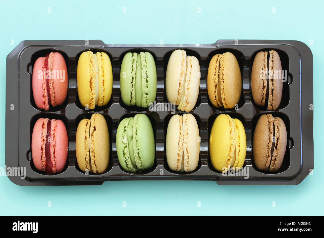 Colorful crunchy macaroons on black plastic box, shot from the top ...