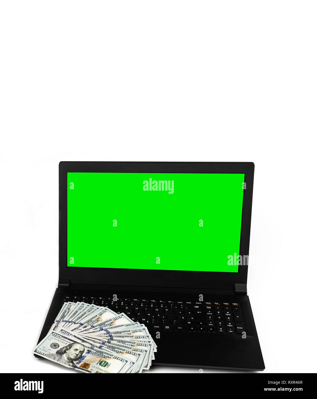 Vertical shot of laptop or notebook with widespread of dollar cash ...