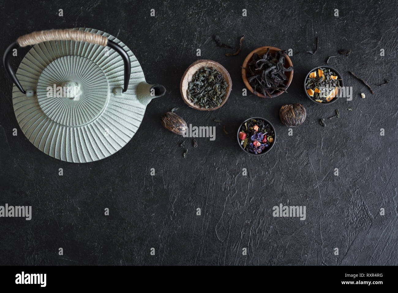 Various Tea Selection and Teapot on black background, copy space ...