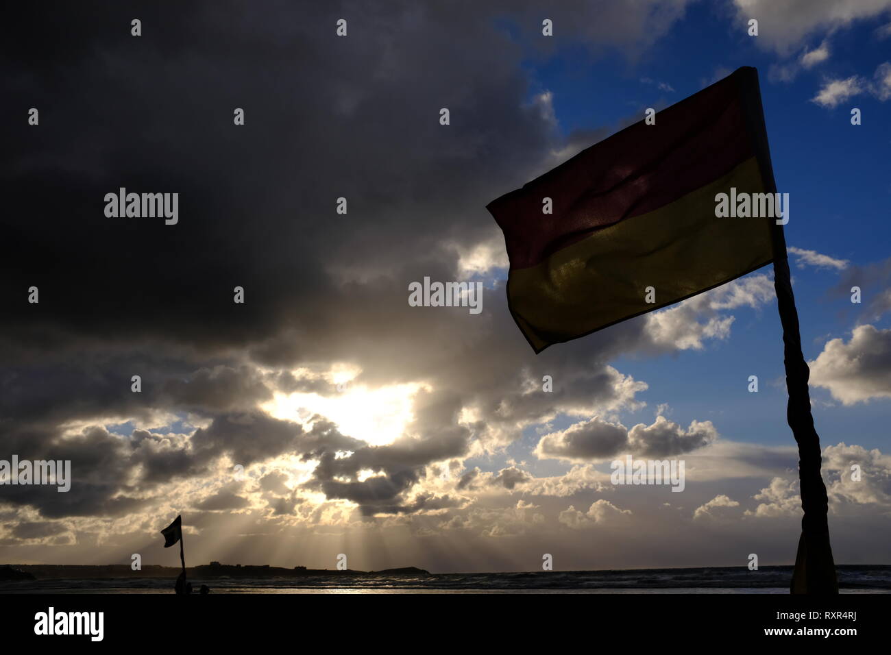 RNLI Flags Red and Yellow with dramatic sky Stock Photo - Alamy