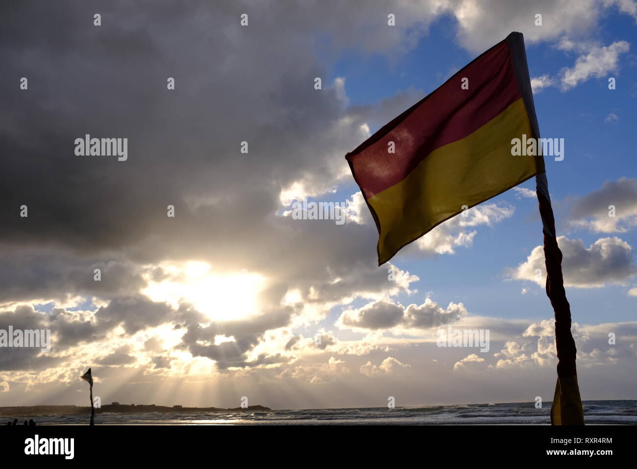 RNLI Flags Red and Yellow with dramatic sky Stock Photo - Alamy