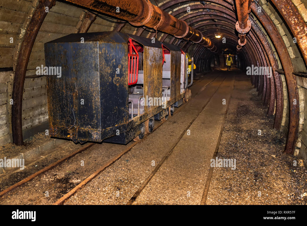 Old and rusty mine train for personnel transfer parked in mine tunnel ...