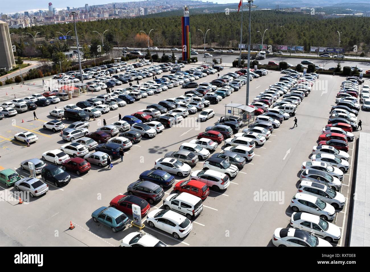 Ankara, Turkey. 09th Mar, 2019. People walk at a car park outside a ...