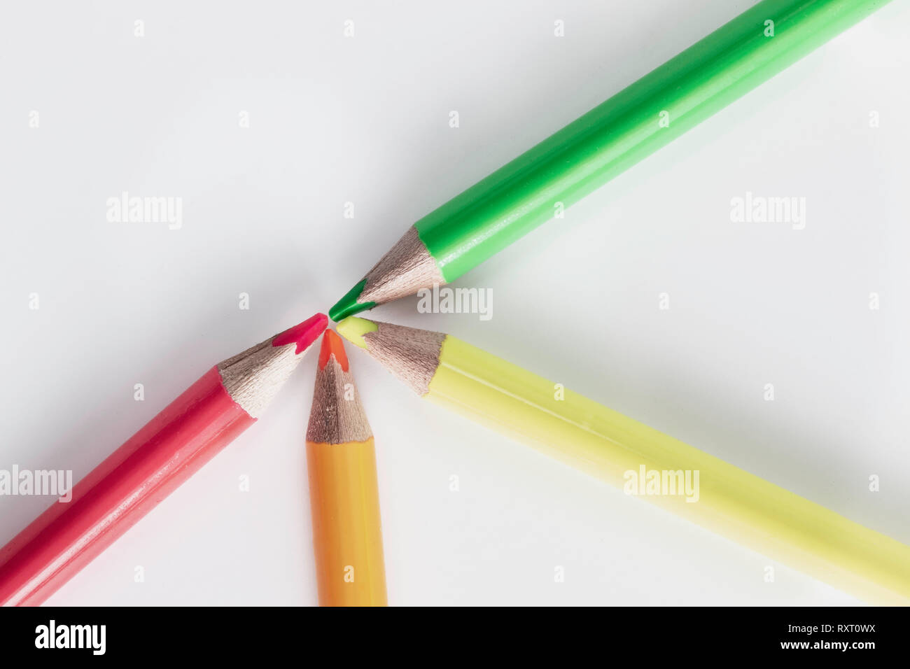 Four neon pencils crayons laid out on a white background Stock Photo ...