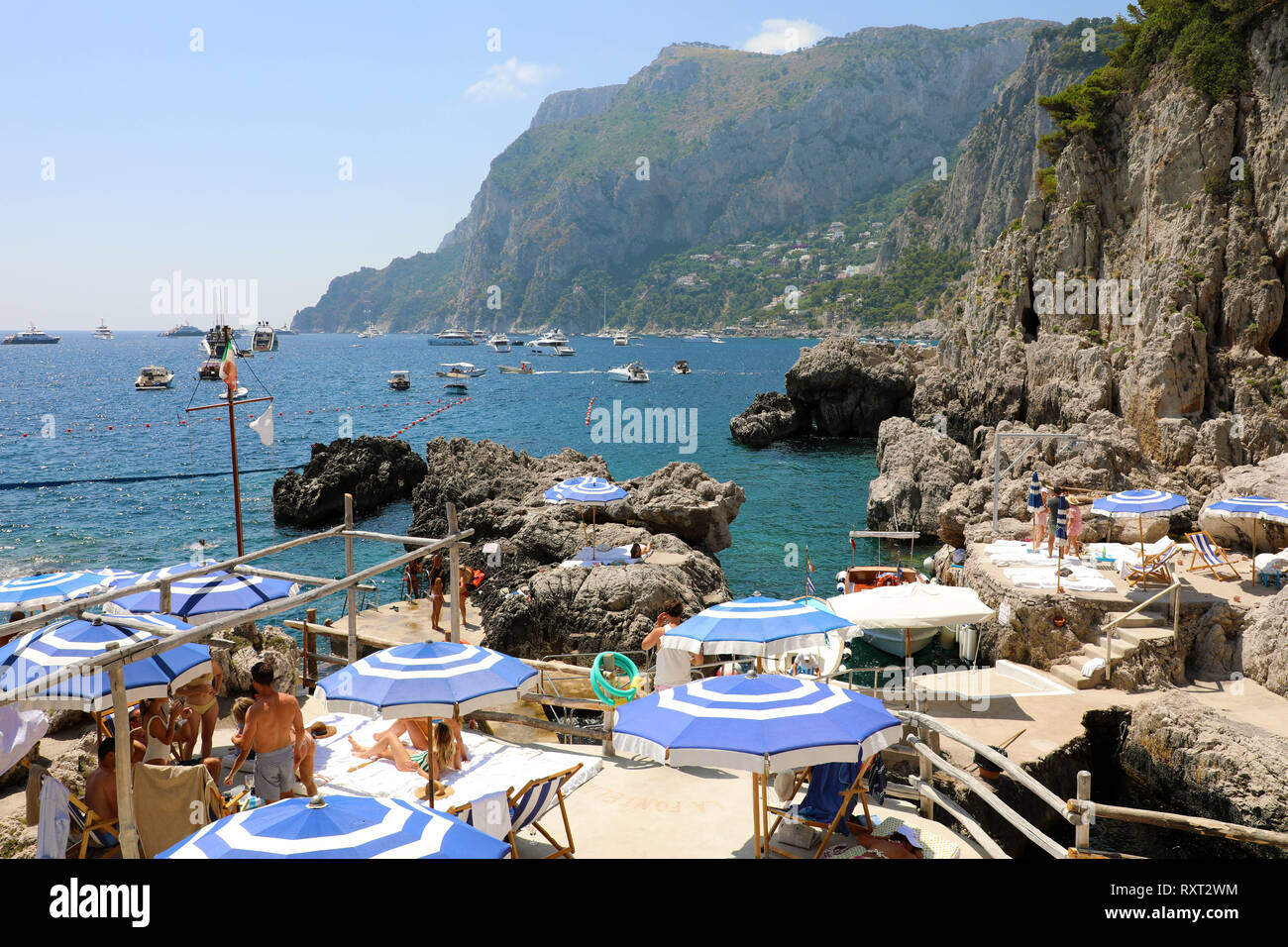 CAPRI, ITALY - JULY 4, 2018: rocky beach between Faraglioni cliffs of ...