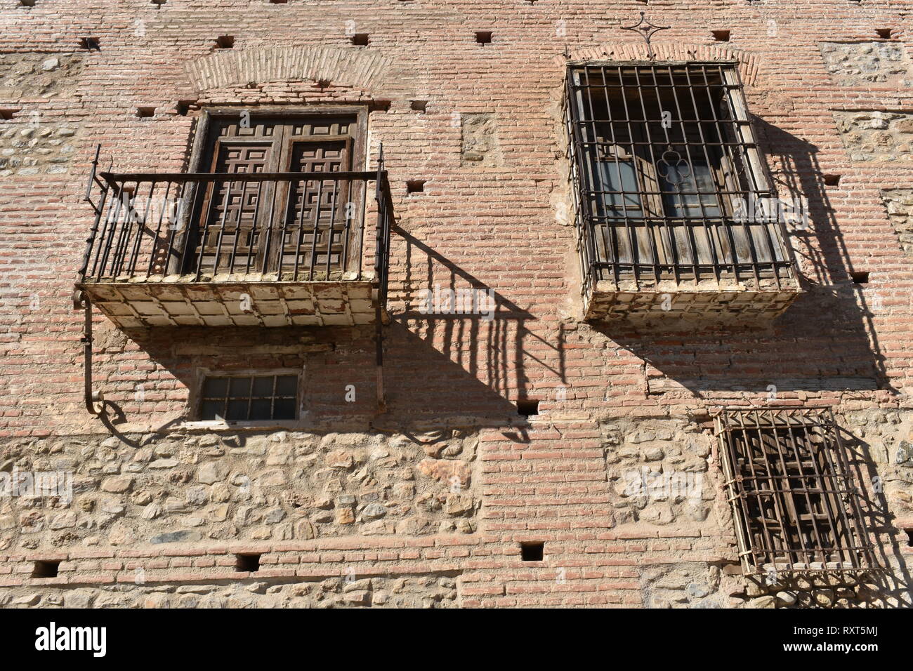 front manor house with wooden balcony and railing iron two windows ...