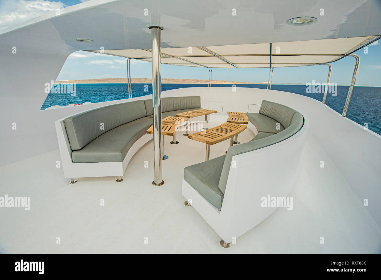 Sundeck area of a large luxury motor yacht with chairs sofa table and ...