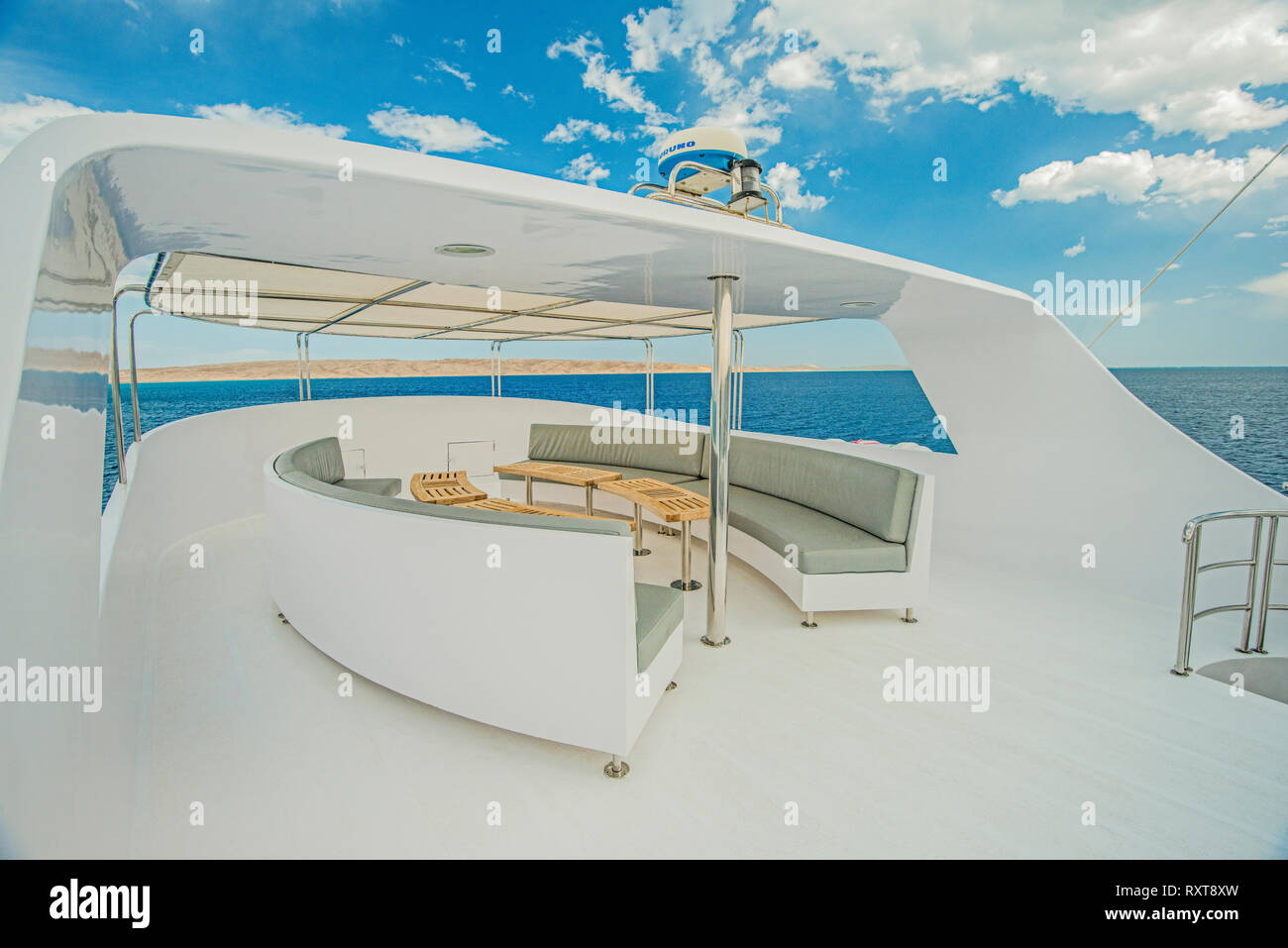 Sundeck area of a large luxury motor yacht with chairs sofa table and ...