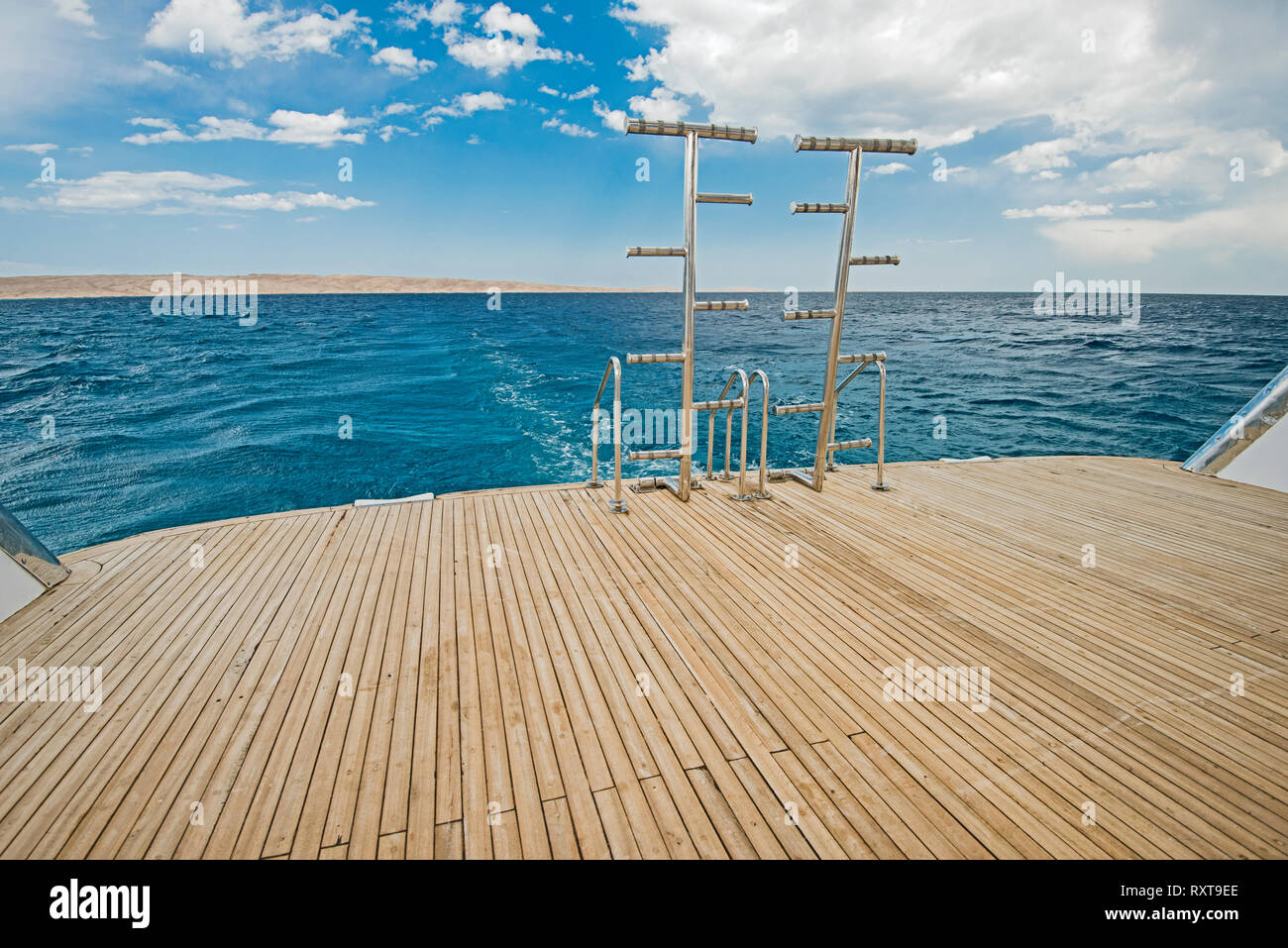 Metal steel ladders on back teak deck of a luxury motor yacht sailing ...