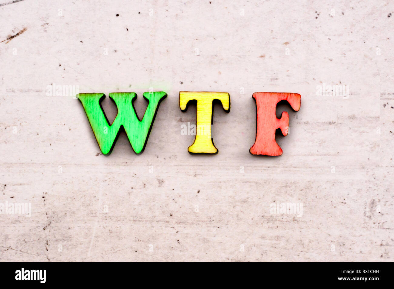 Inscription wtf COLORED abbreviation in wooden letters on a light ...