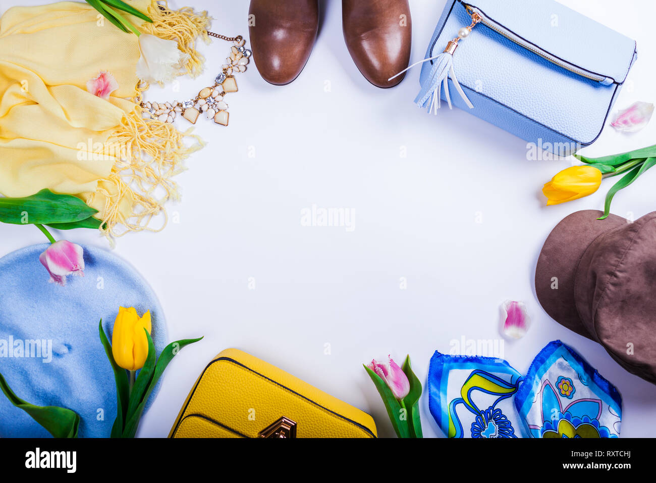 Spring female clothes, accessories and jewellery with tulips on white ...