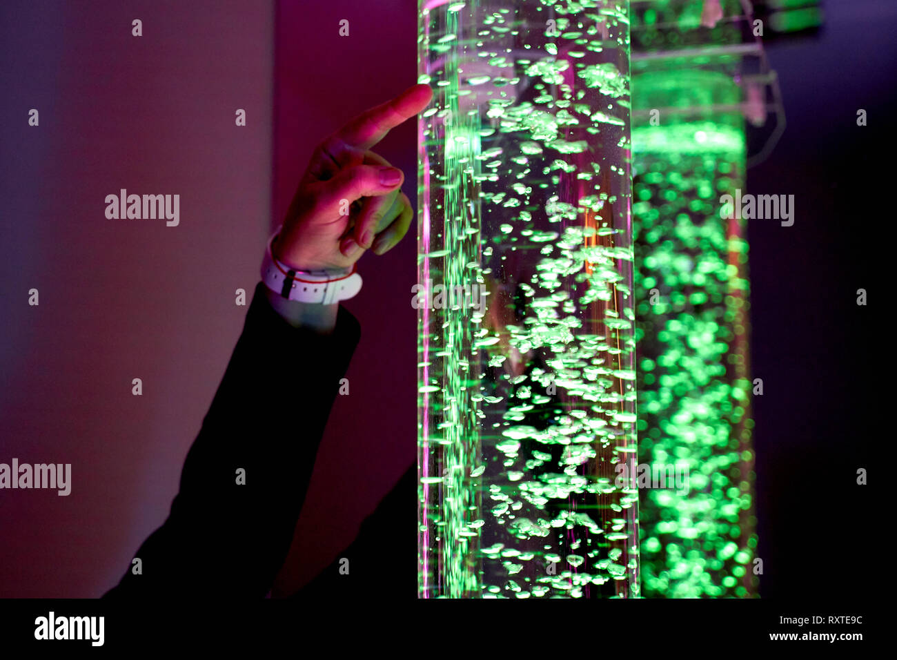 therapy sensory stimulating multi sensory room, woman interacting with ...