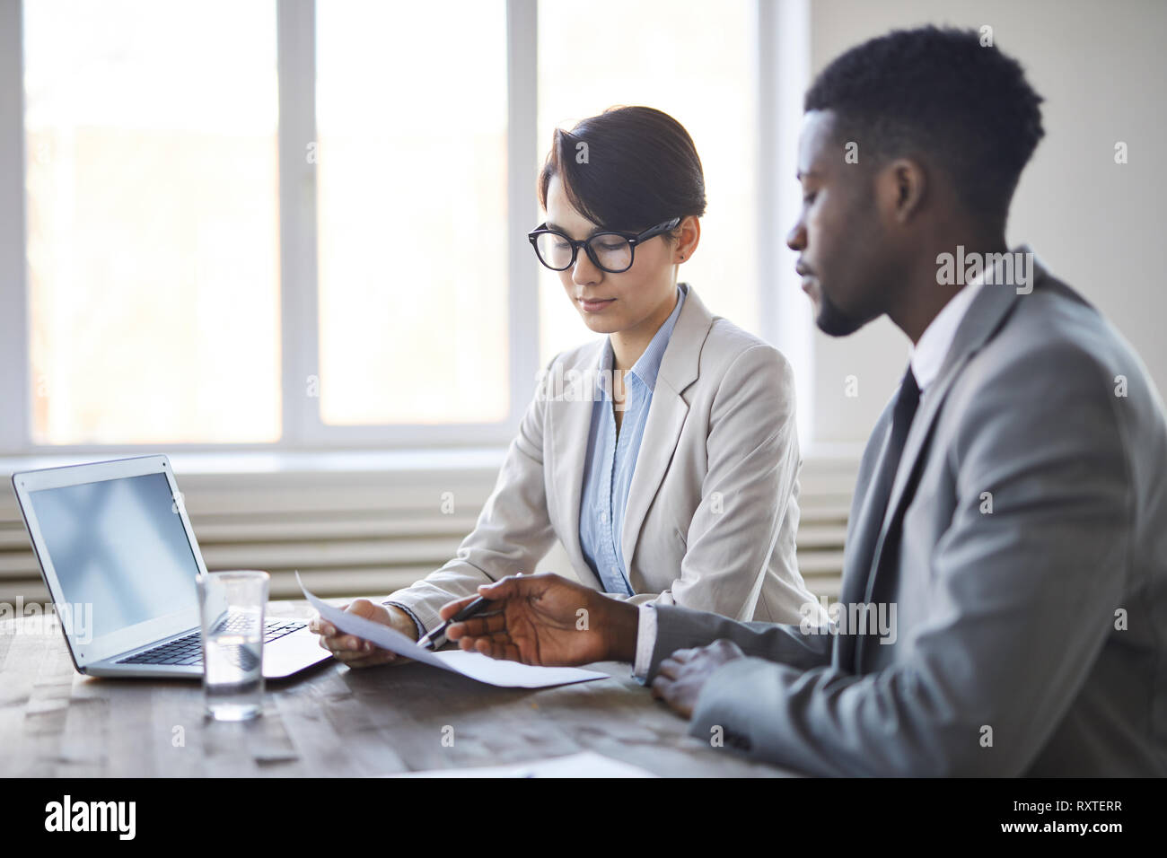 Businessman showing document colleague hi-res stock photography and ...