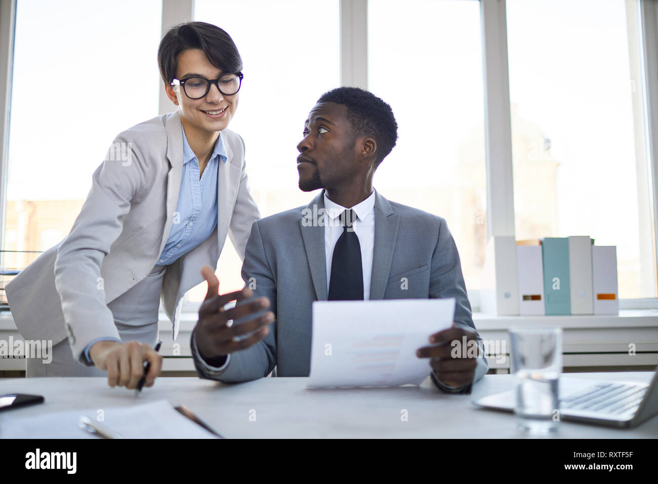Showing contract to colleague Stock Photo - Alamy